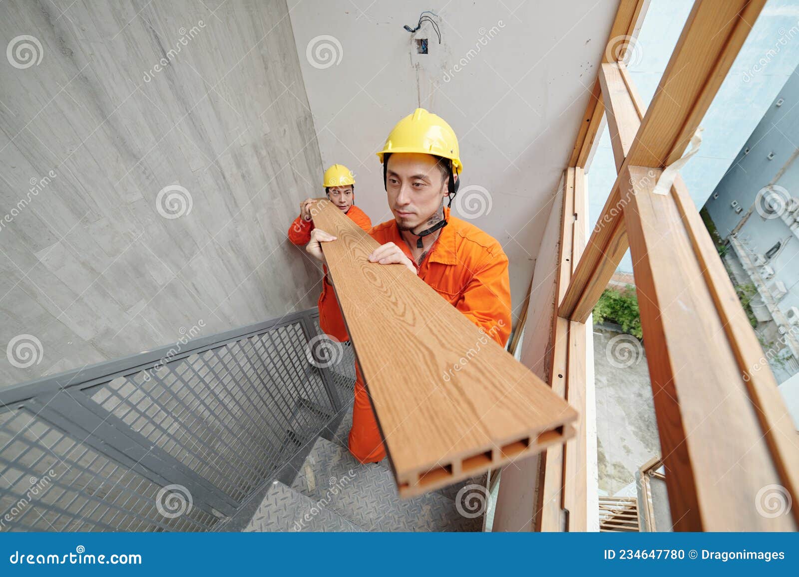 Construction Workers Carrying Building Materials Stock Photo - Image of ...