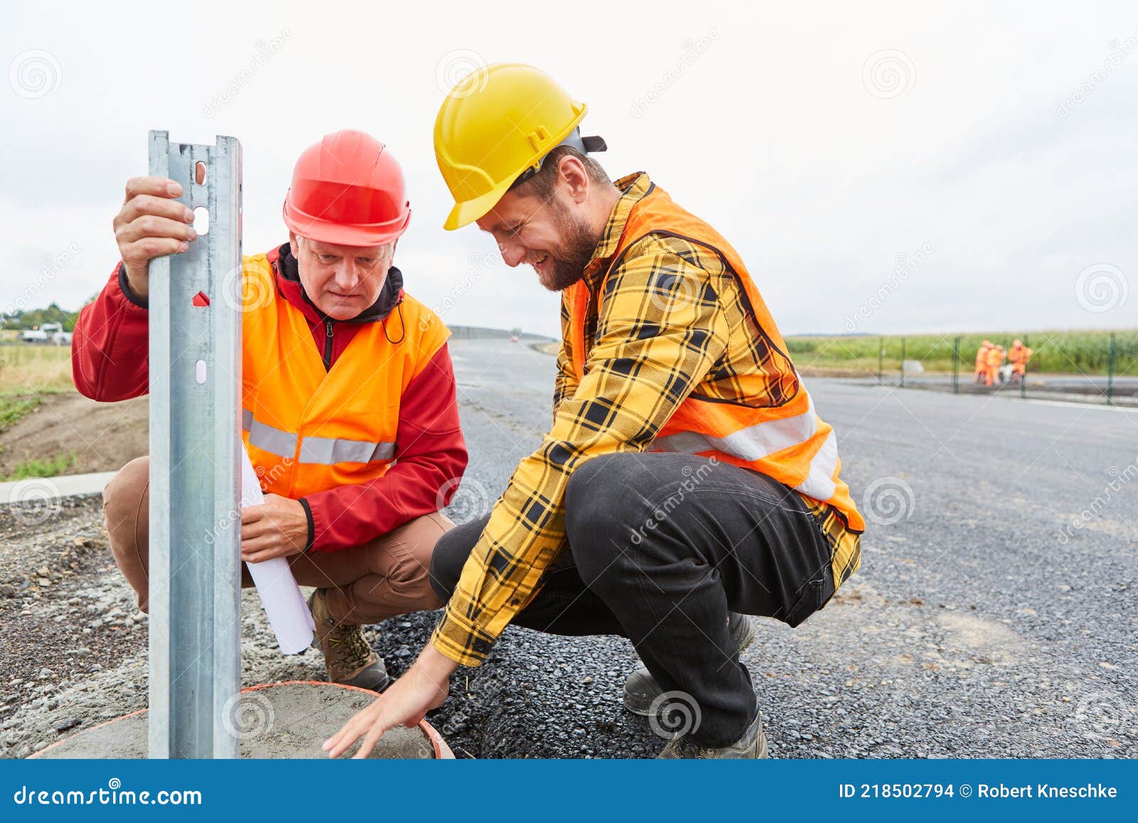 Construction Workers Check Foundation for Guard Rails Stock Photo ...