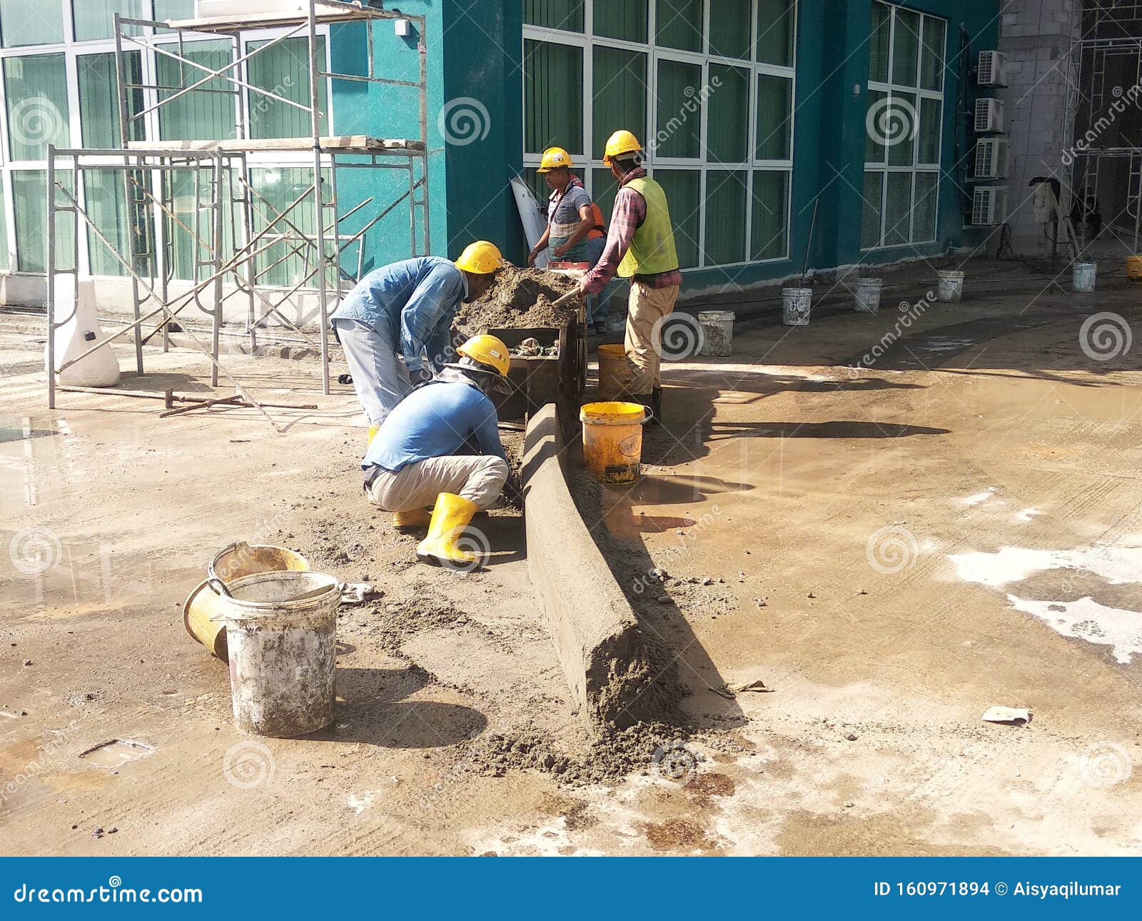 Construction Workers Creating Concrete Road Curb at the Construction ...