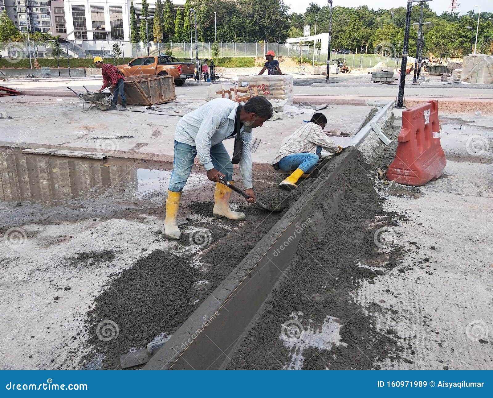 Construction Workers Creating Concrete Road Curb at the Construction ...