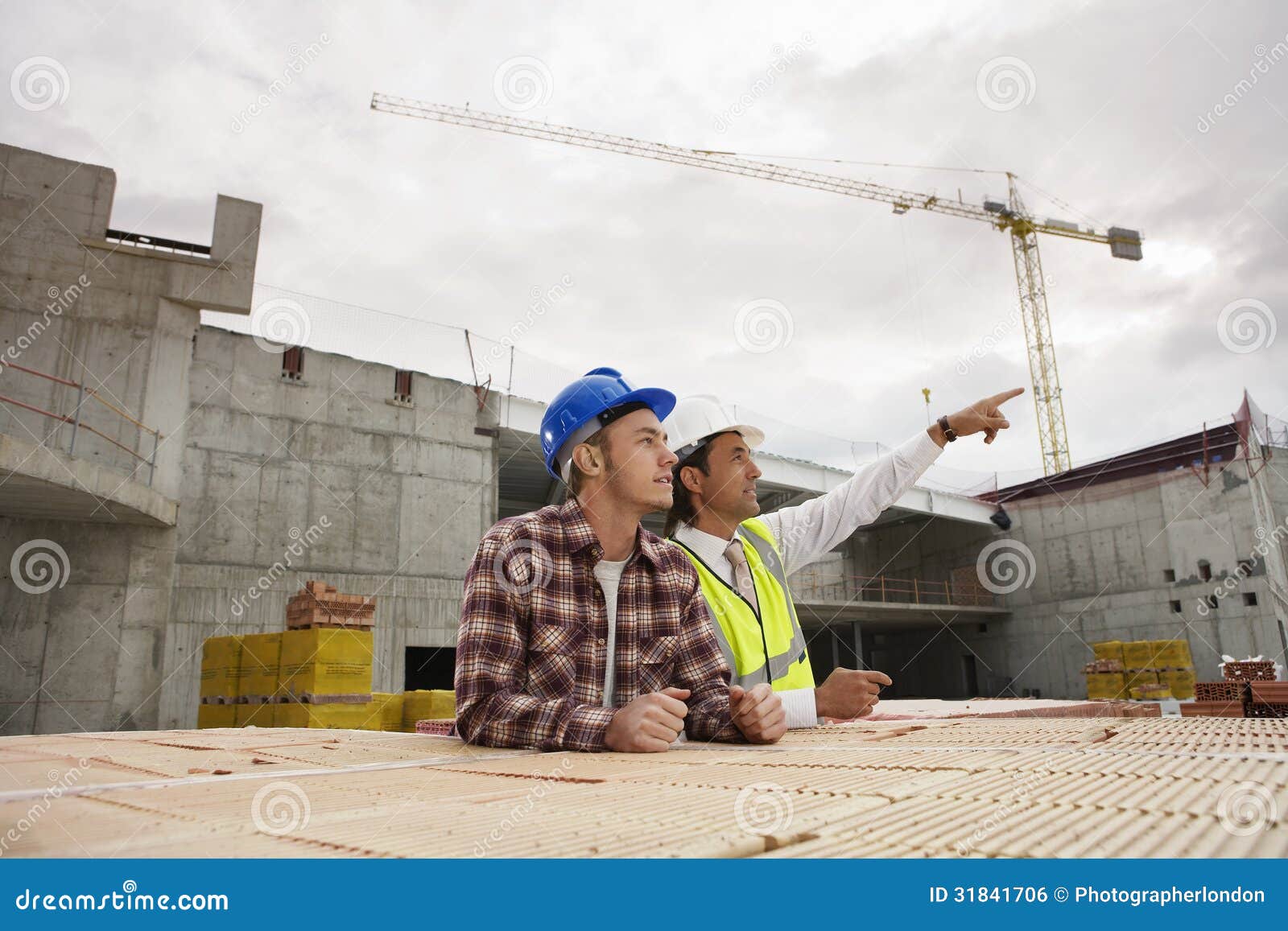 Construction Workers Discussing Job Stock Photo - Image of looking ...