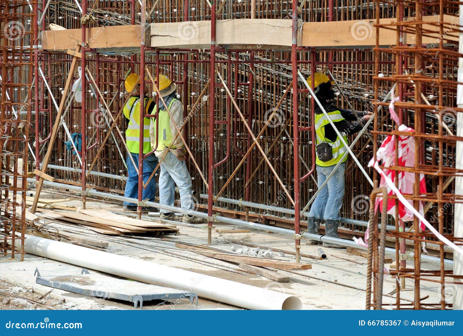 Construction Workers Fabricate Steel Reinforcement for Concrete Wall at ...