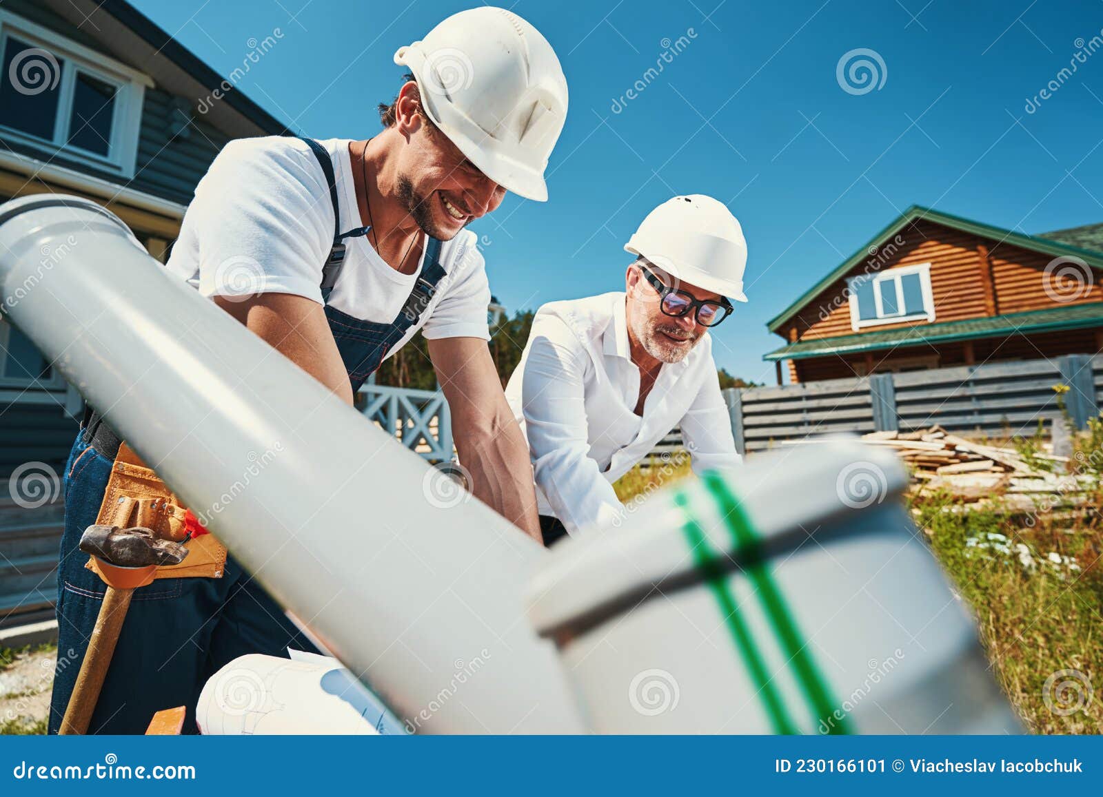 Construction Workers in Helmets Leaning Over Table Stock Image - Image ...