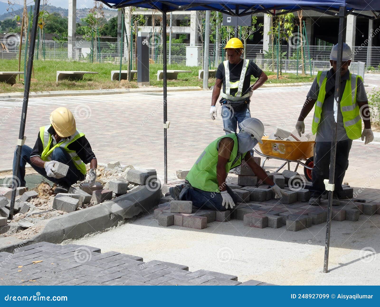 Construction Workers Installing and Arranging Precast Concrete Pavers ...