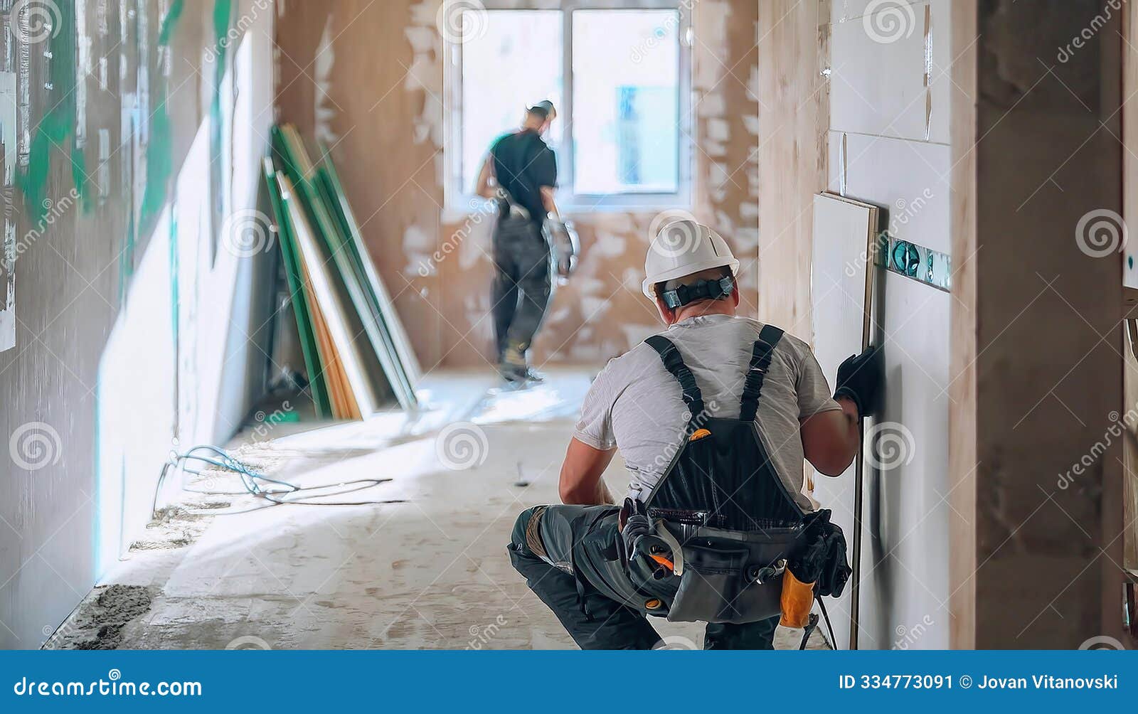 Construction Workers Installing Drywall at Building Site with Natural ...