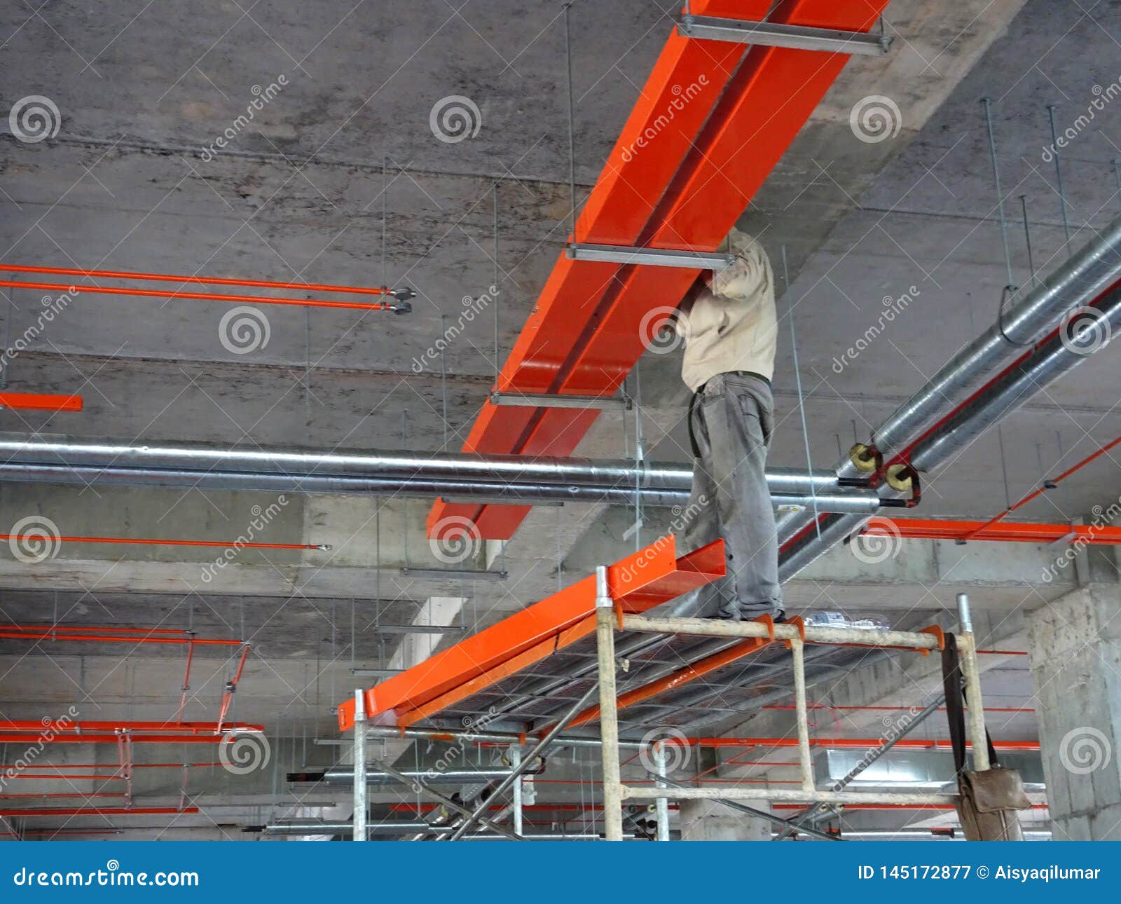 Construction Workers Installing Electrical Cable Tray And Doing Wiring ...