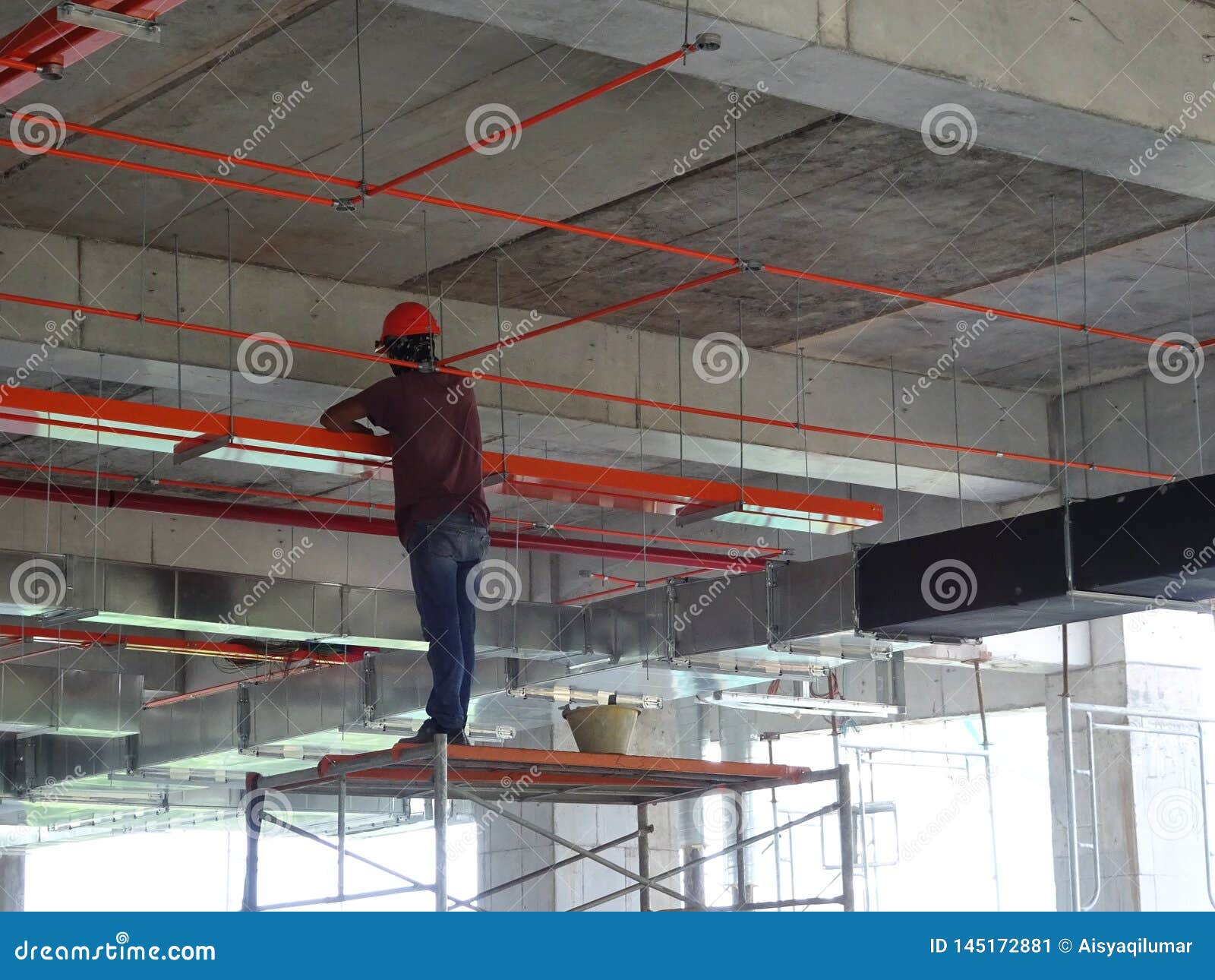 Construction Workers Installing Electrical Cable Tray and Doing Wiring ...
