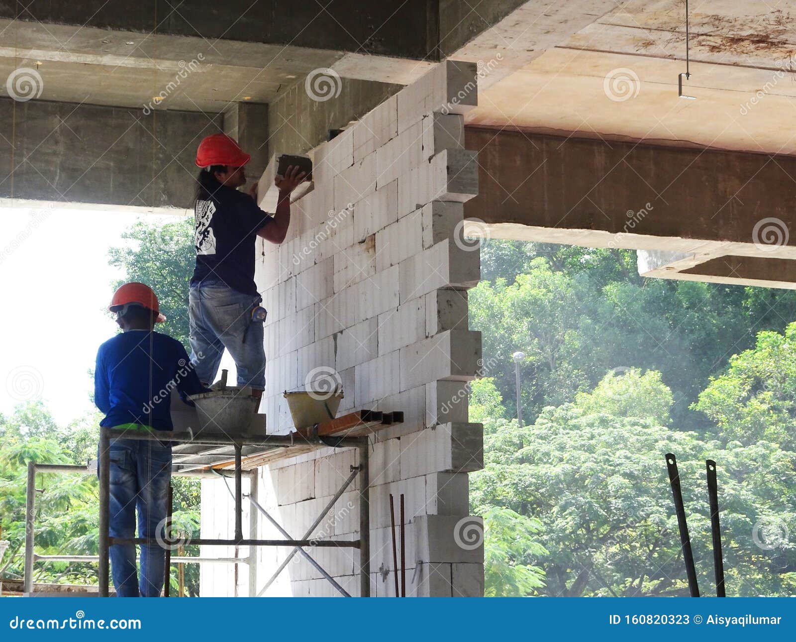 Construction Workers Installing Lightweight Block Bricks To Become Wall ...