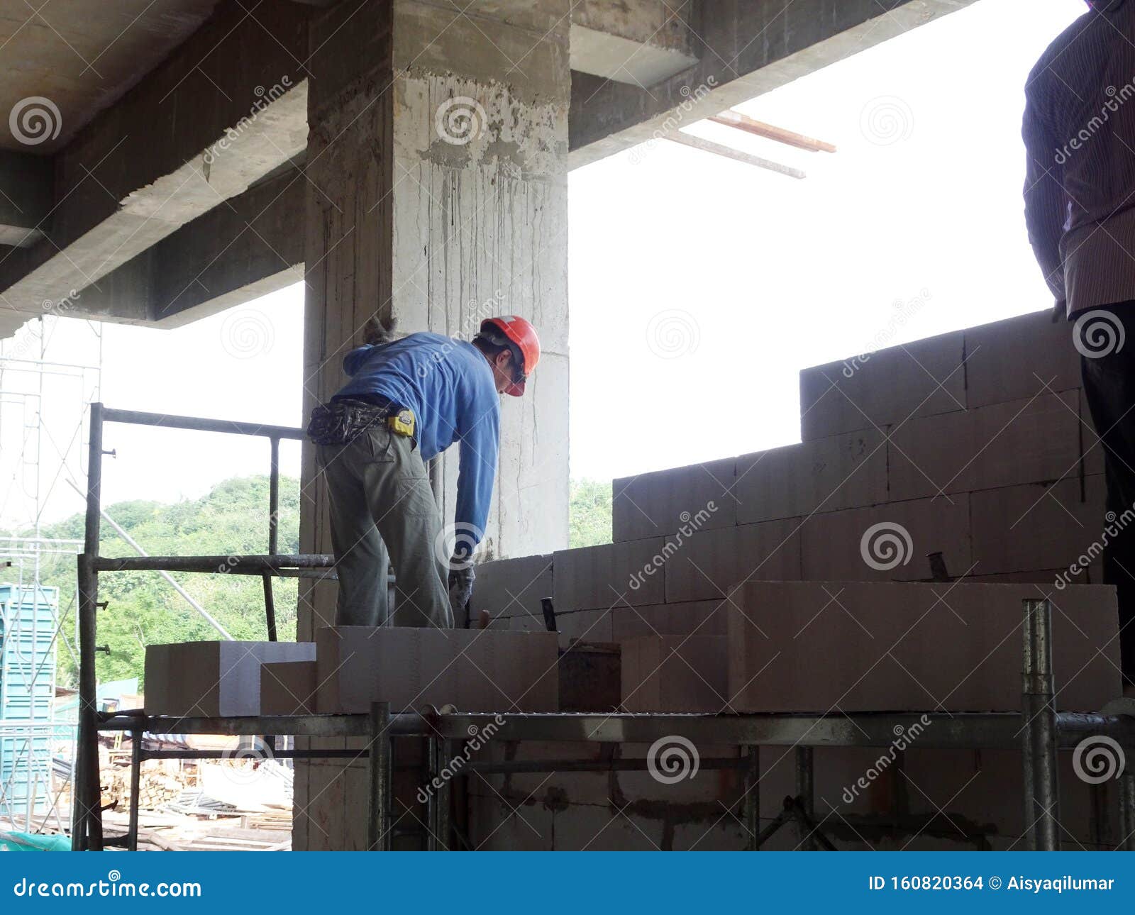 Construction Workers Installing Lightweight Block Bricks To Become Wall ...