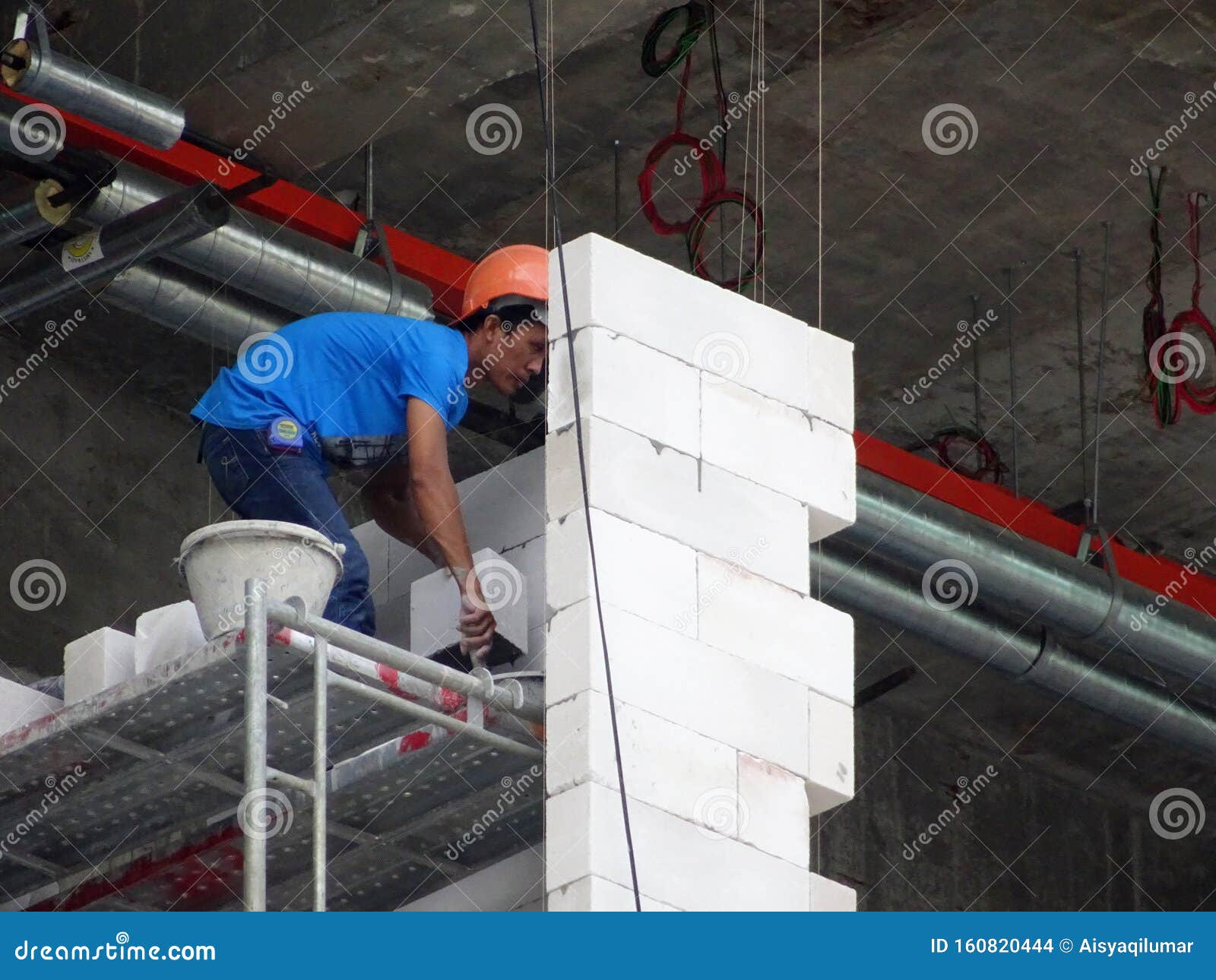 Construction Workers Installing Lightweight Block Bricks To Become Wall ...