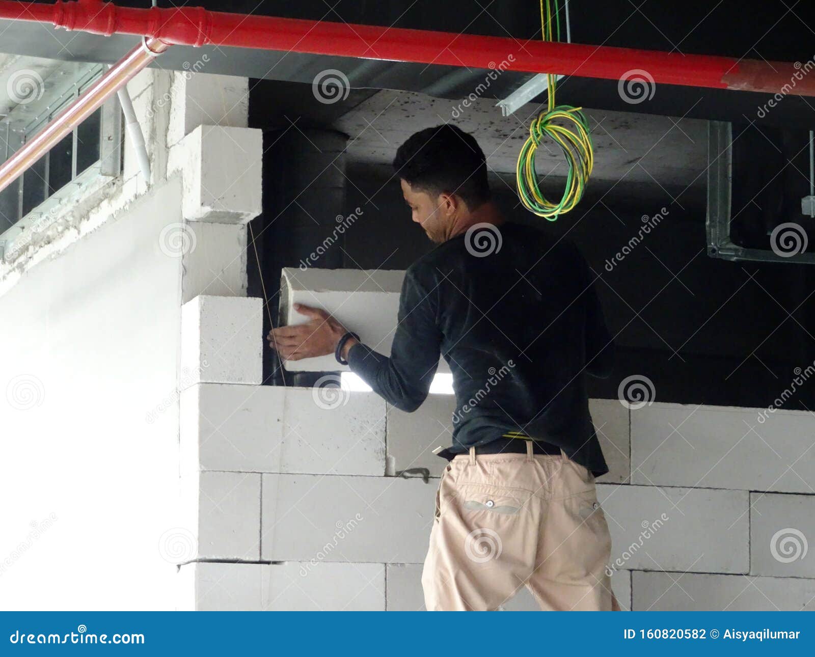 Construction Workers Installing Lightweight Block Bricks To Become Wall ...