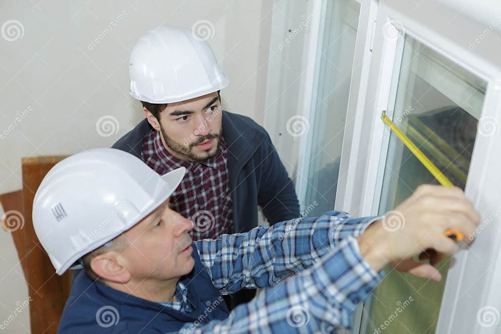 Construction Workers Installing New Windows in House Stock Photo - Image of thirties, tool ...