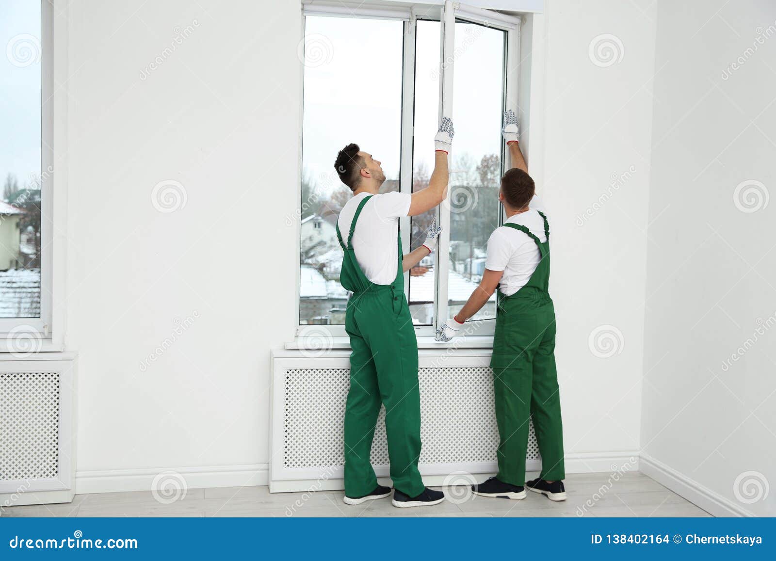Construction Workers Installing Plastic Window Stock Photo - Image of ...