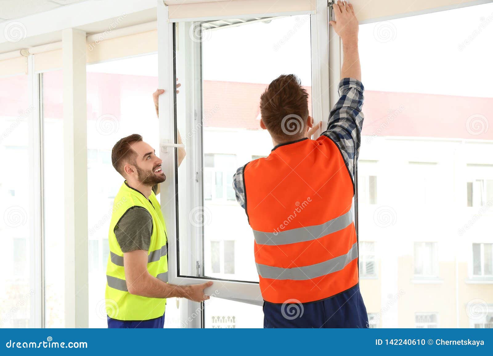 Construction Workers Installing Plastic Window Stock Photo - Image of ...
