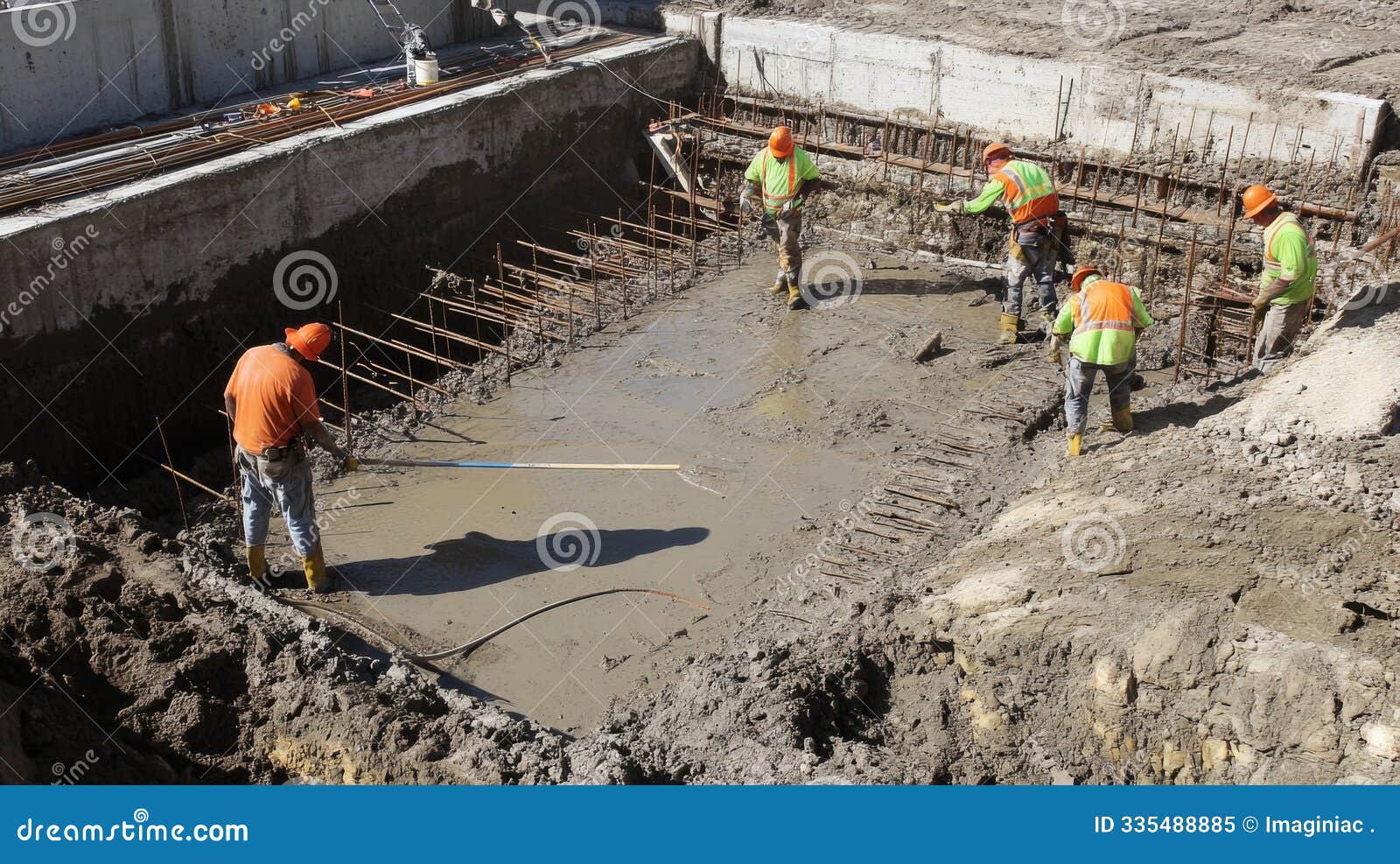 Construction Workers Leveling Concrete at a Construction Site Stock ...
