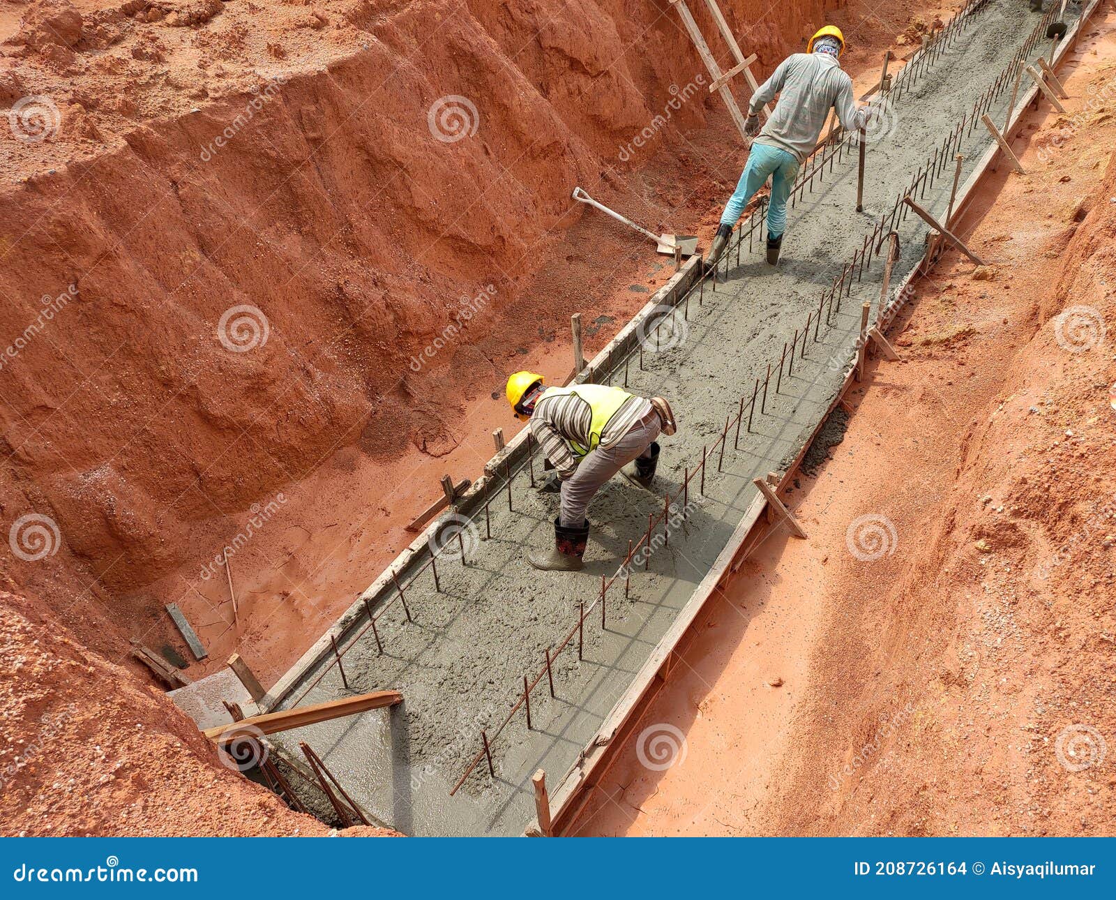 Construction Workers are Levelling a Layer of Lean Concrete in the ...