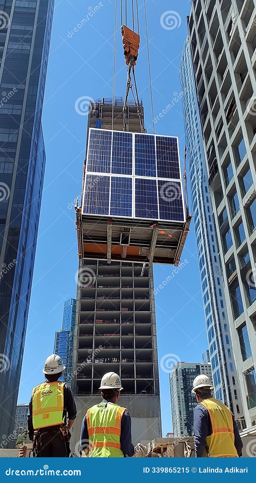 Construction Workers Lifting Solar Panels with a Crane Stock ...