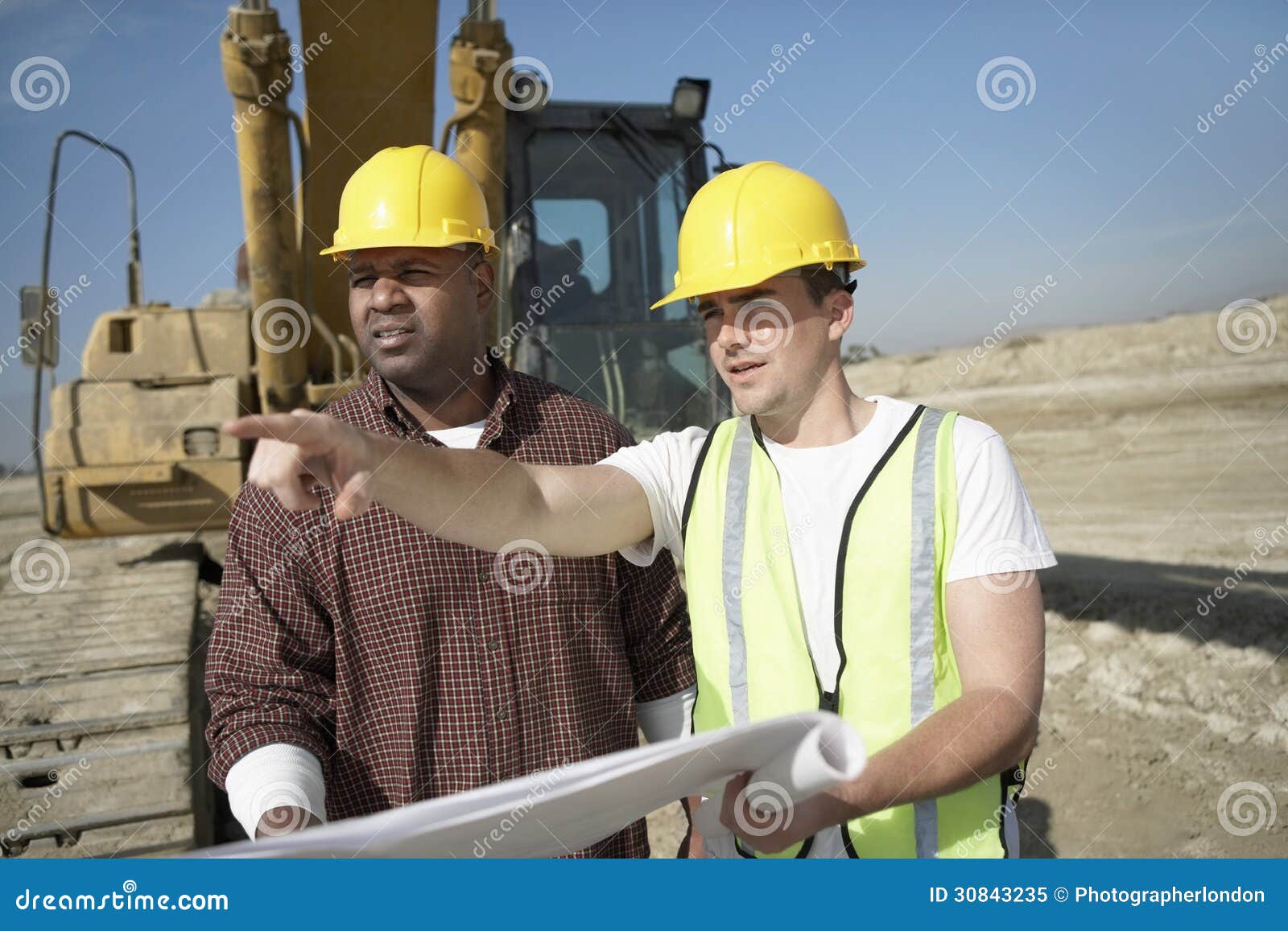 Construction Workers Looking at Plan on Site Stock Image - Image of ...