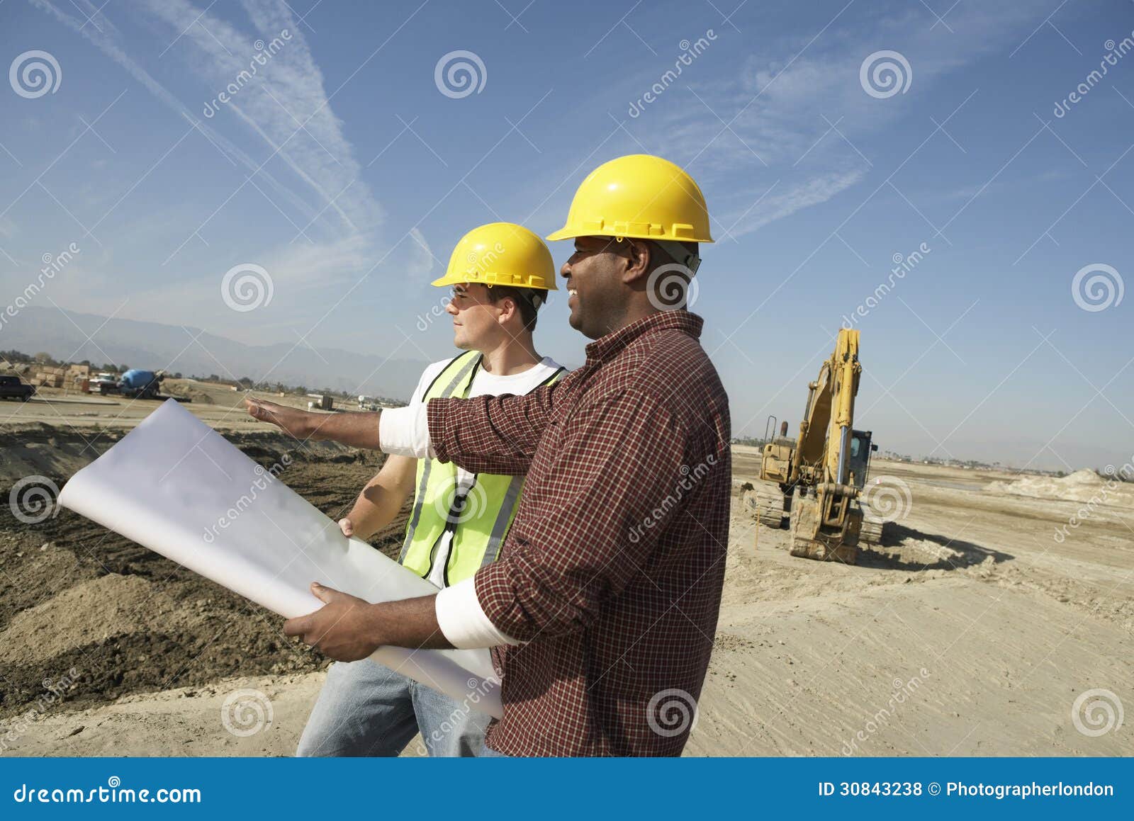 Construction Workers Looking at Plan on Site Stock Photo - Image of ...