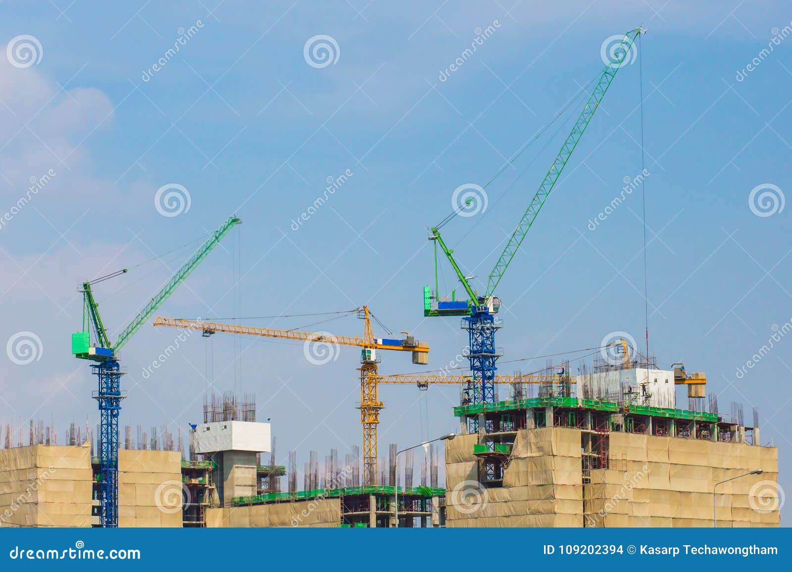 Construction Workers Man Lifting Heavy Reinforcement Bar in the Stock ...