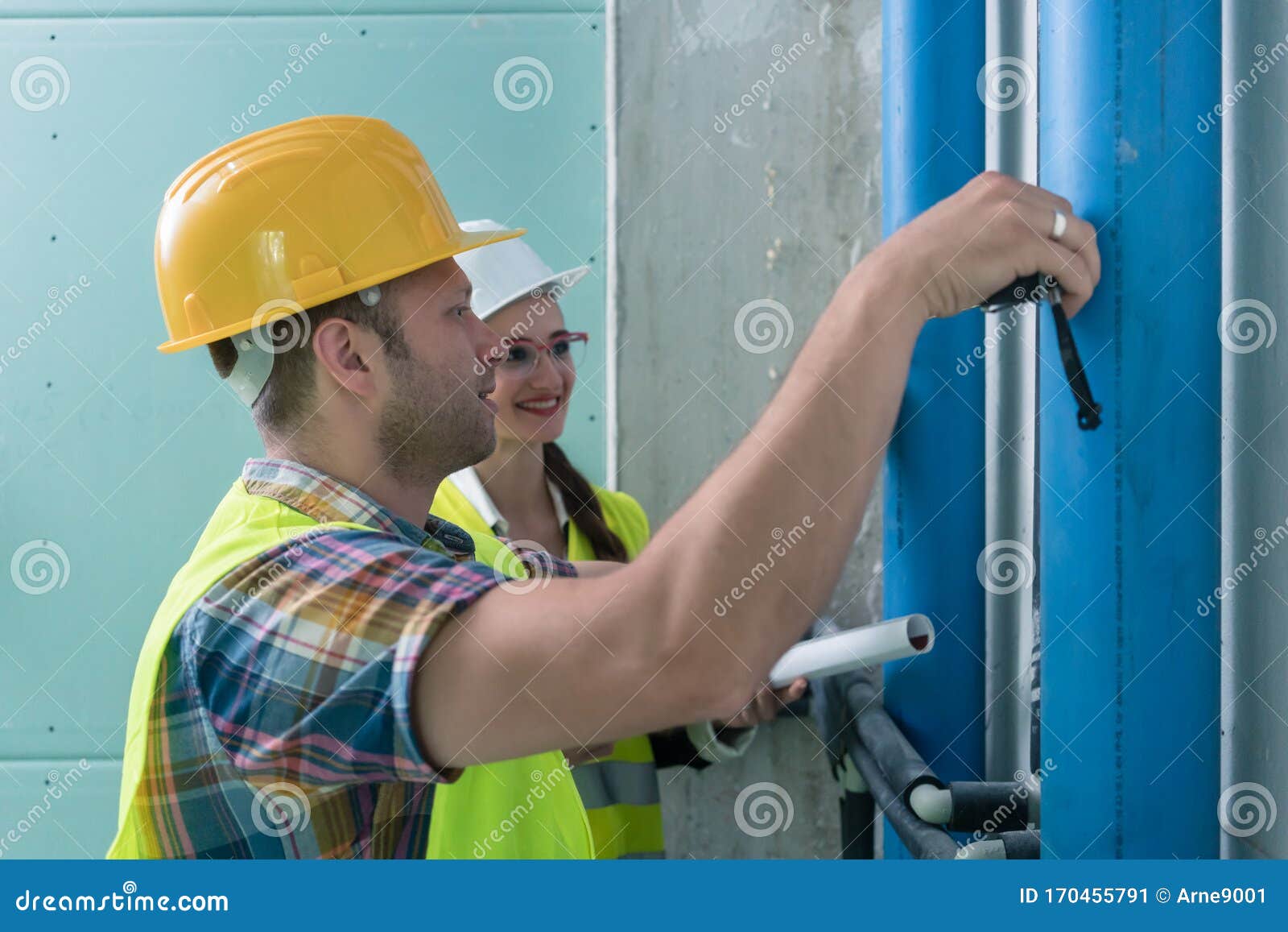 Construction Workers Measuring Pipes on Site Stock Image - Image of ...