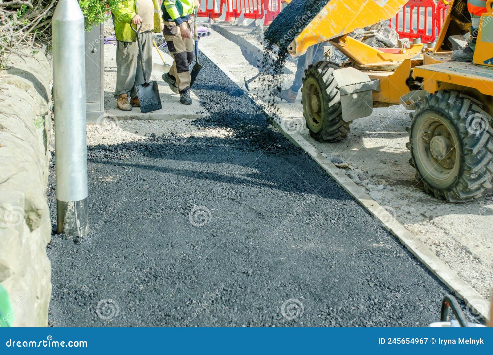 Groundworker Placing Wet Concrete Inside Formwork During Roadworks ...