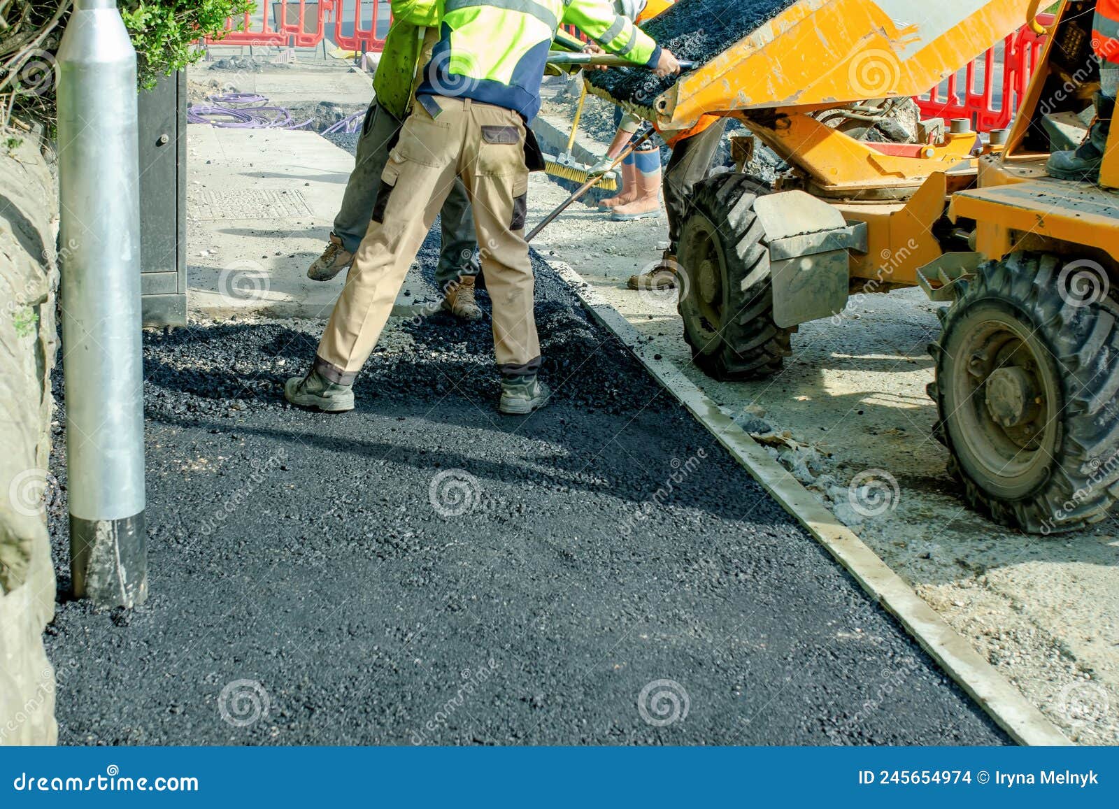 Groundworker Placing Wet Concrete Inside Formwork During Roadworks ...