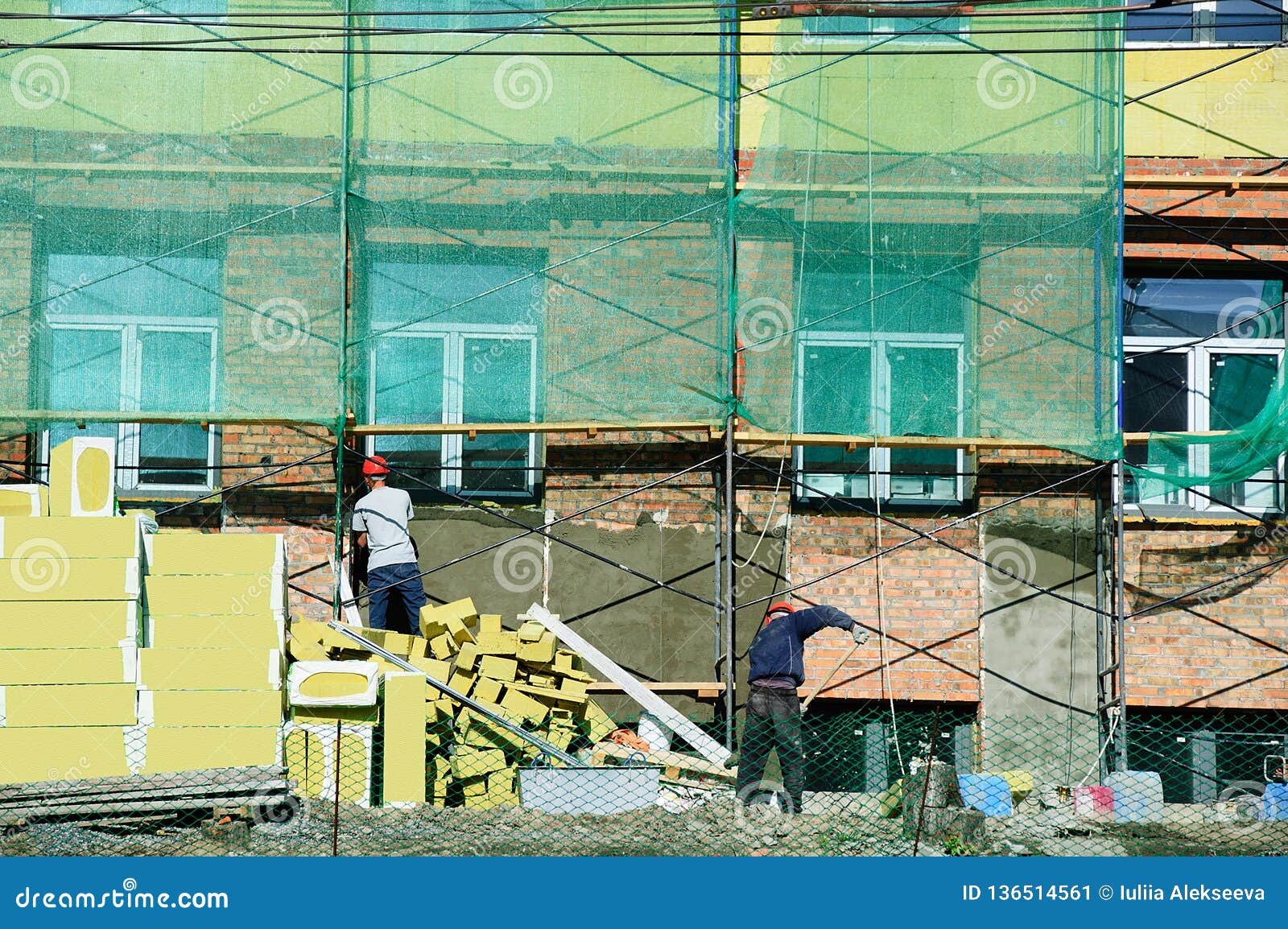 Construction Workers Plaster the Facade of the Building. Restoration of ...