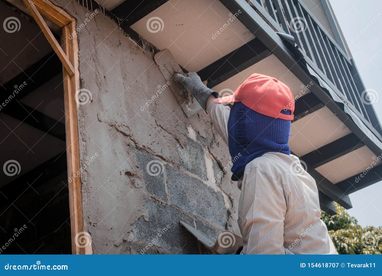 Construction Workers Plastering Building Wall Using Cement Plaster ...