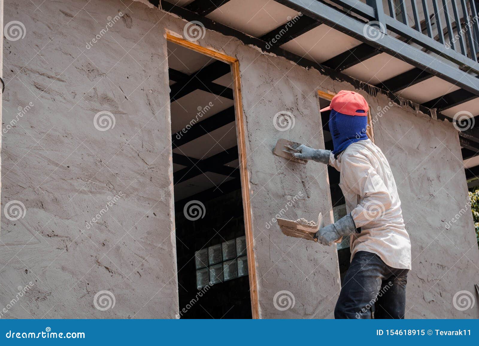 Construction Workers Plastering Building Wall Using Cement Plaster ...