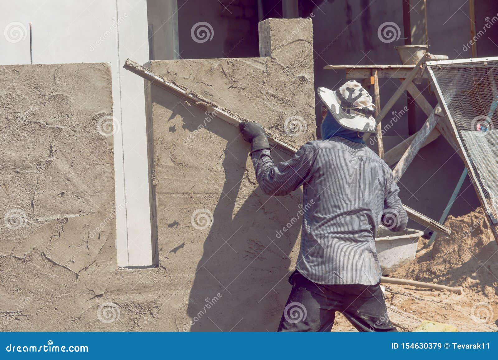 Construction Workers Plastering Building Wall Using Cement Plaster ...