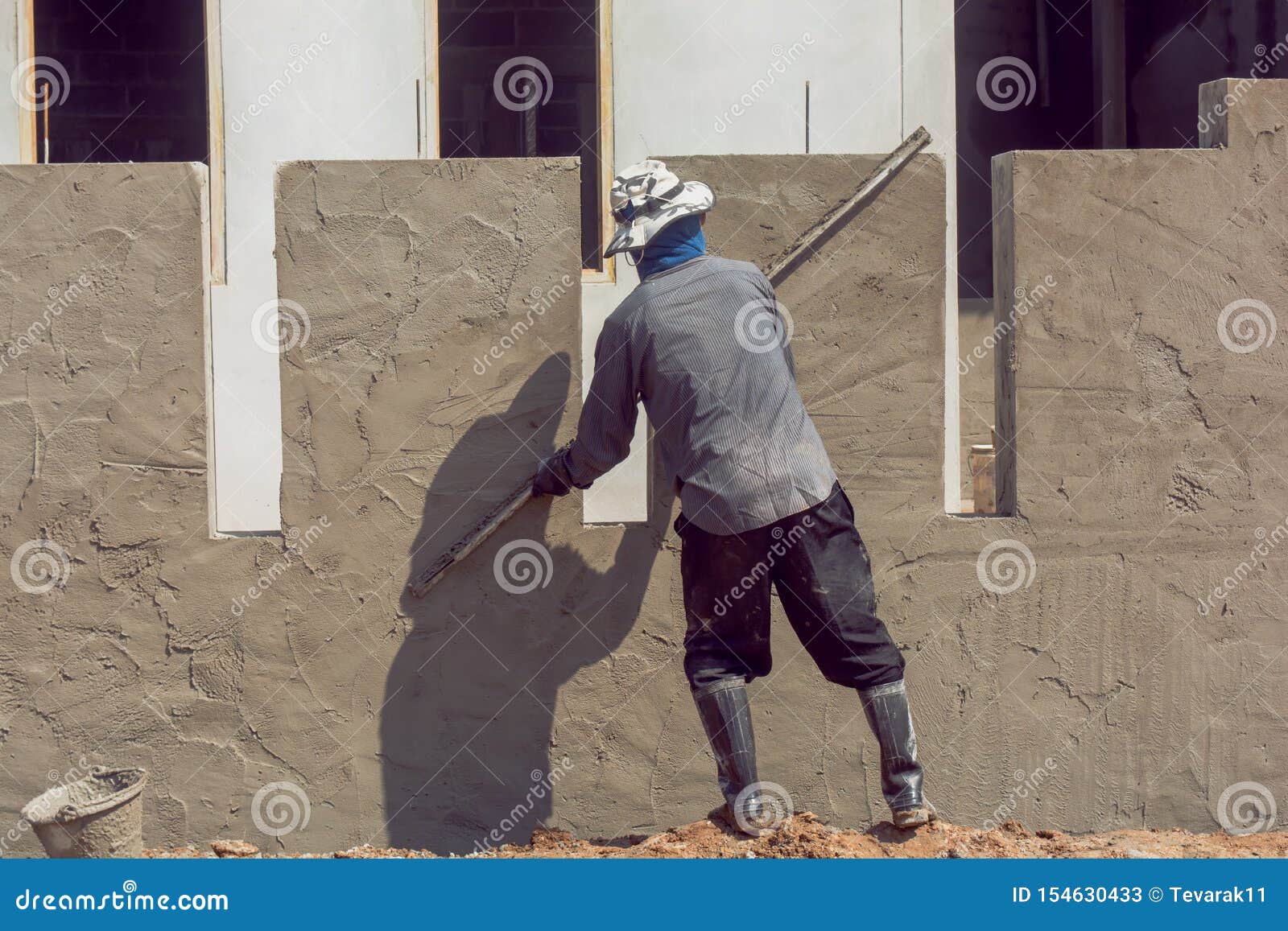 Construction Workers Plastering Building Wall Using Cement Plaster ...