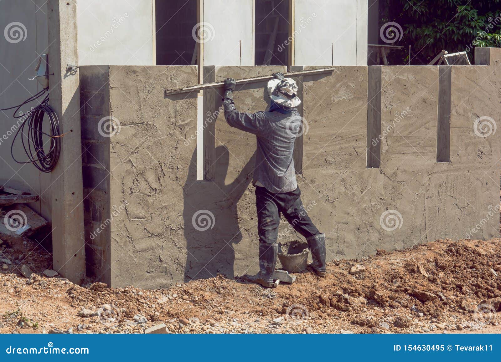 Construction Workers Plastering Building Wall Using Cement Plaster ...