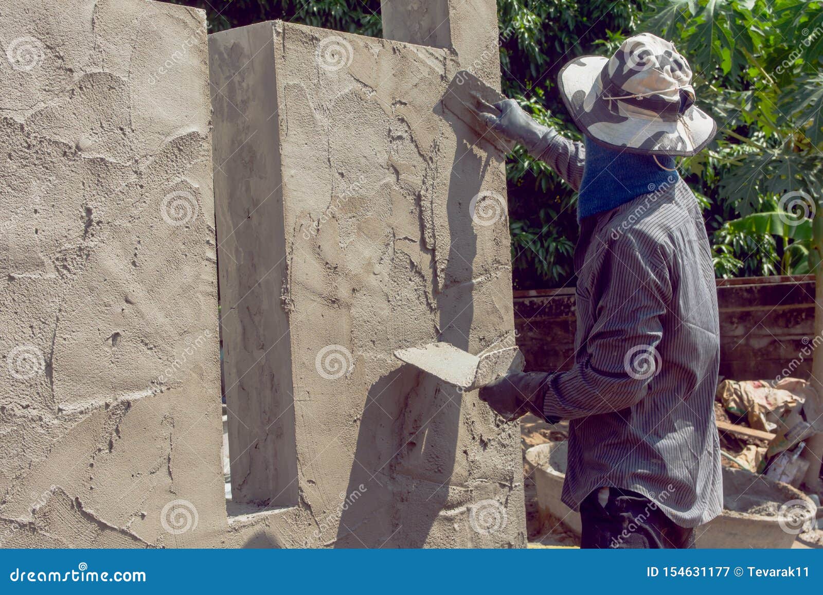 Construction Workers Plastering Building Wall Using Cement Plaster ...