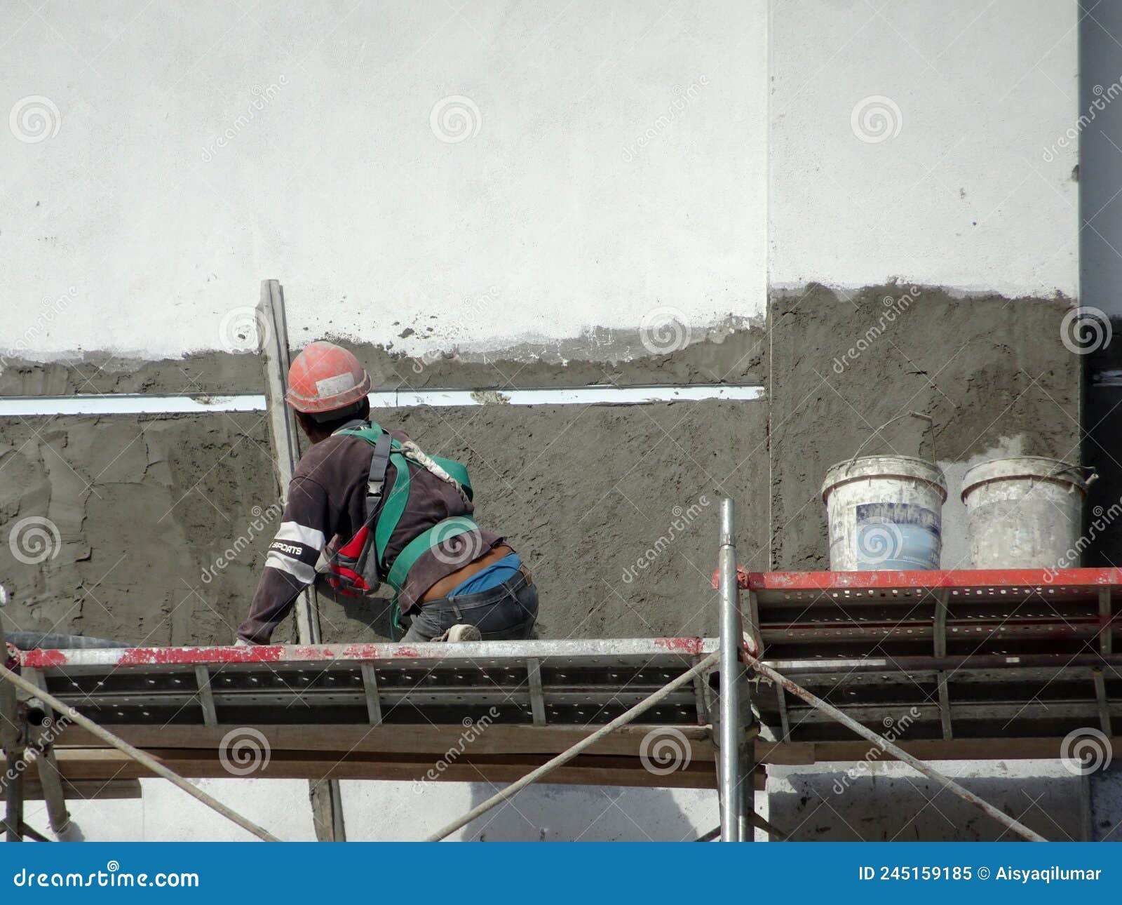 Construction Workers Plastering Wall Using Cement Plaster at the ...