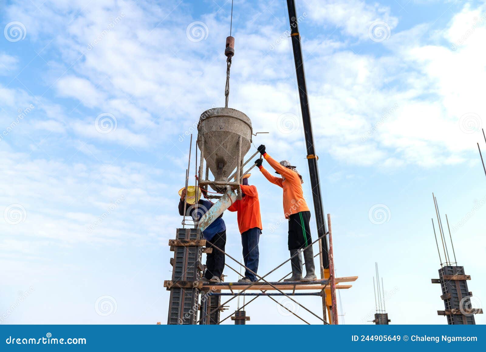 Construction Workers Pour Concrete Column at the Construction Site ...