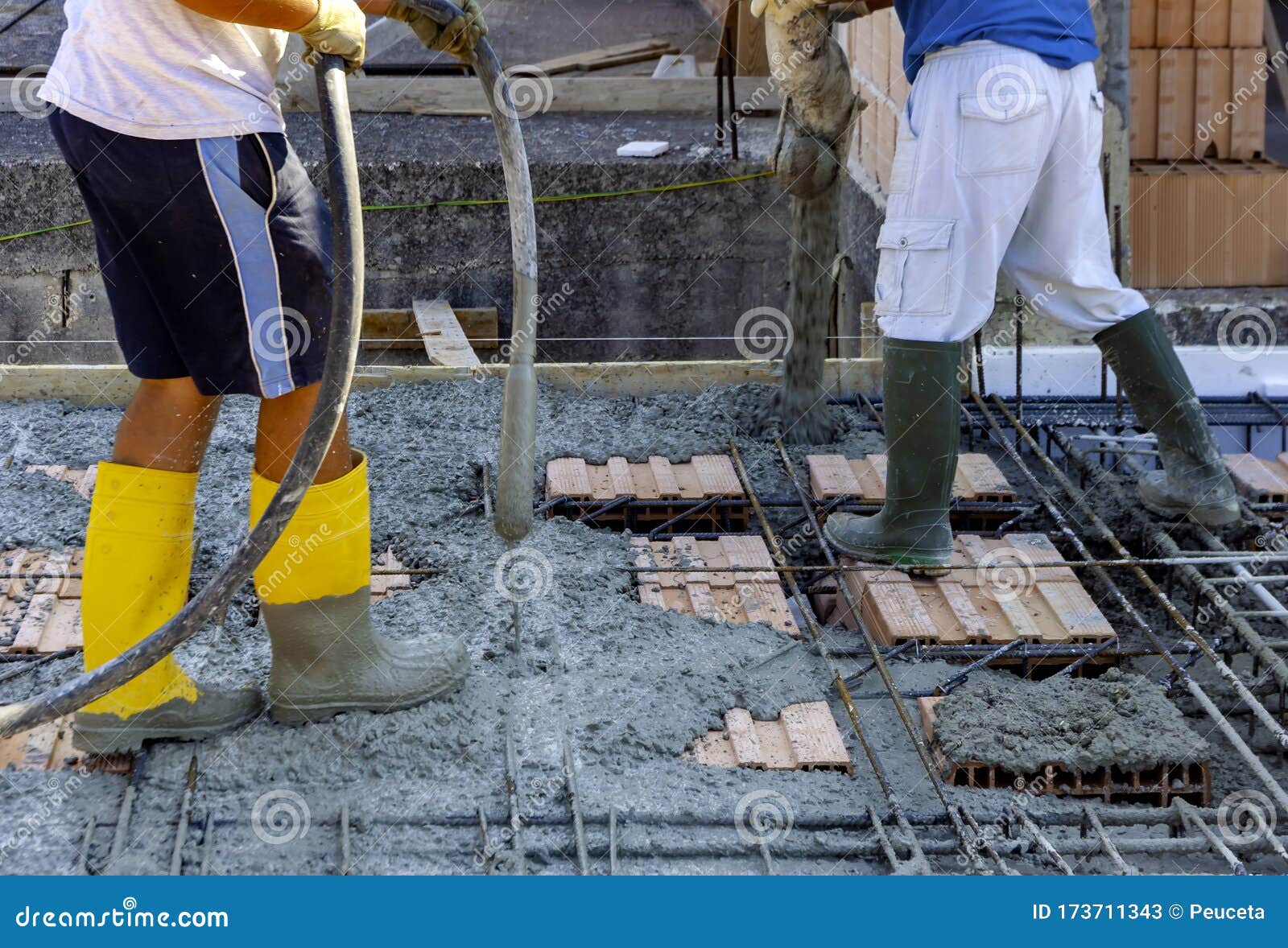 Construction Workers Pour Concrete for the Execution of a Reinforced ...