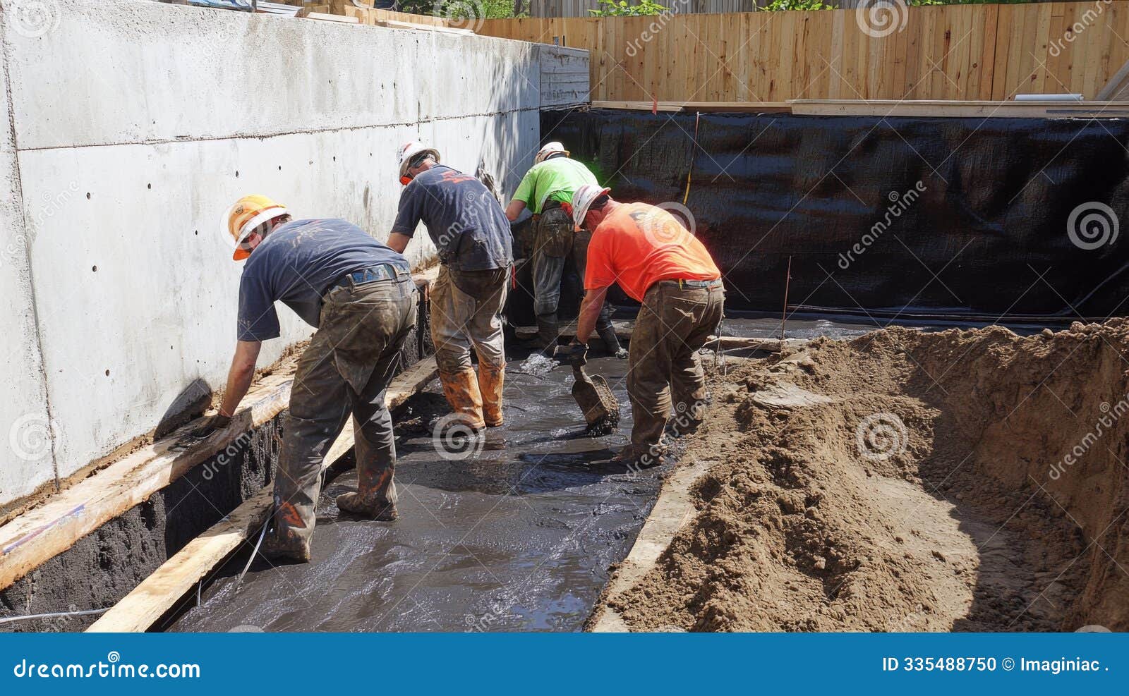 Construction Workers Pouring Concrete during a Basement Waterproofing ...