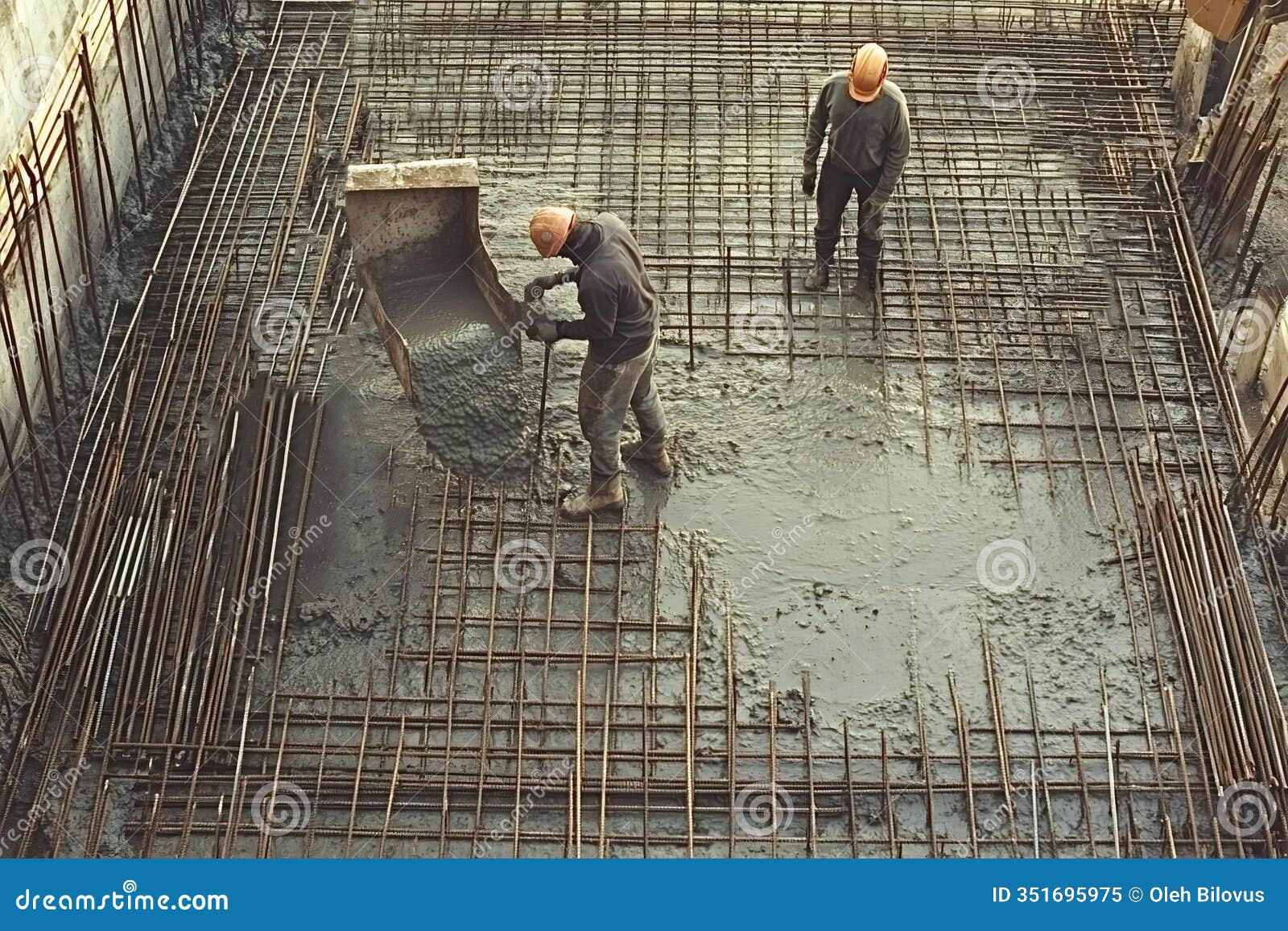Construction Workers Pouring Concrete Over Rebar Grid at Building Site ...