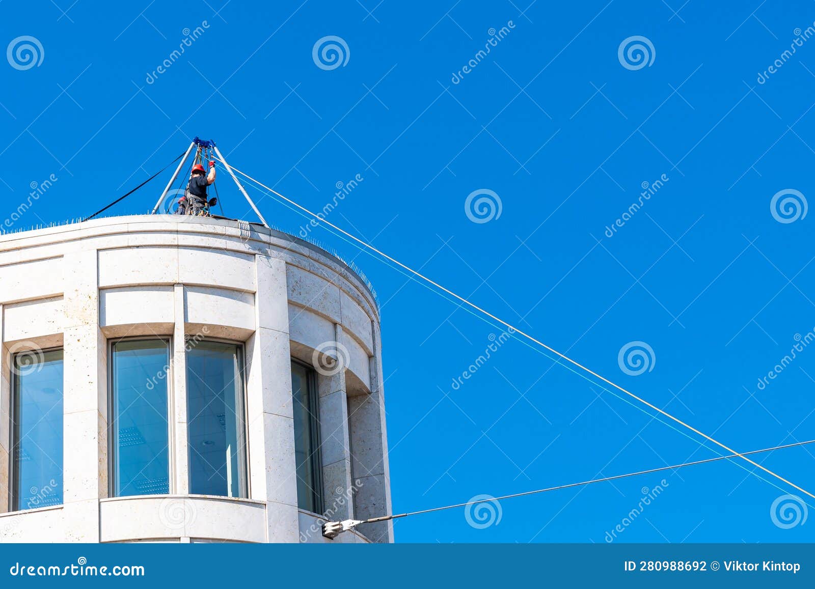 Construction Workers Pull a Rope on the Roof of a Building. Stock Photo ...