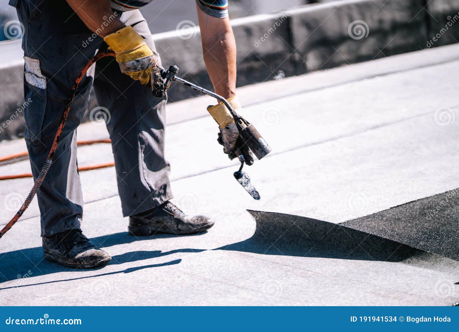 Workers Waterproofing Flat Concrete Roof Using Blowtorch And Bituminous ...