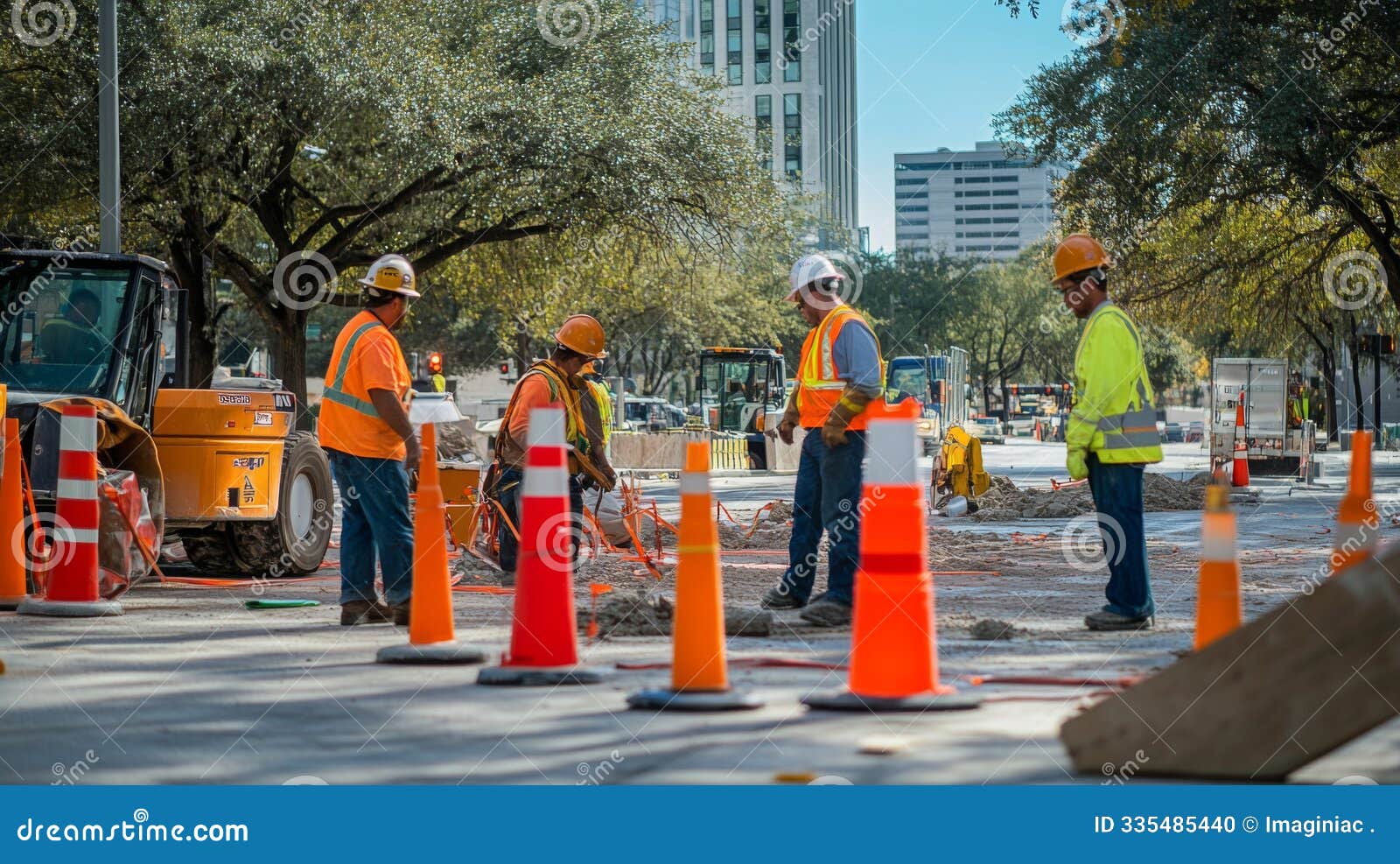 Construction Workers in Safety Gear Near Traffic Cones and Excavator ...