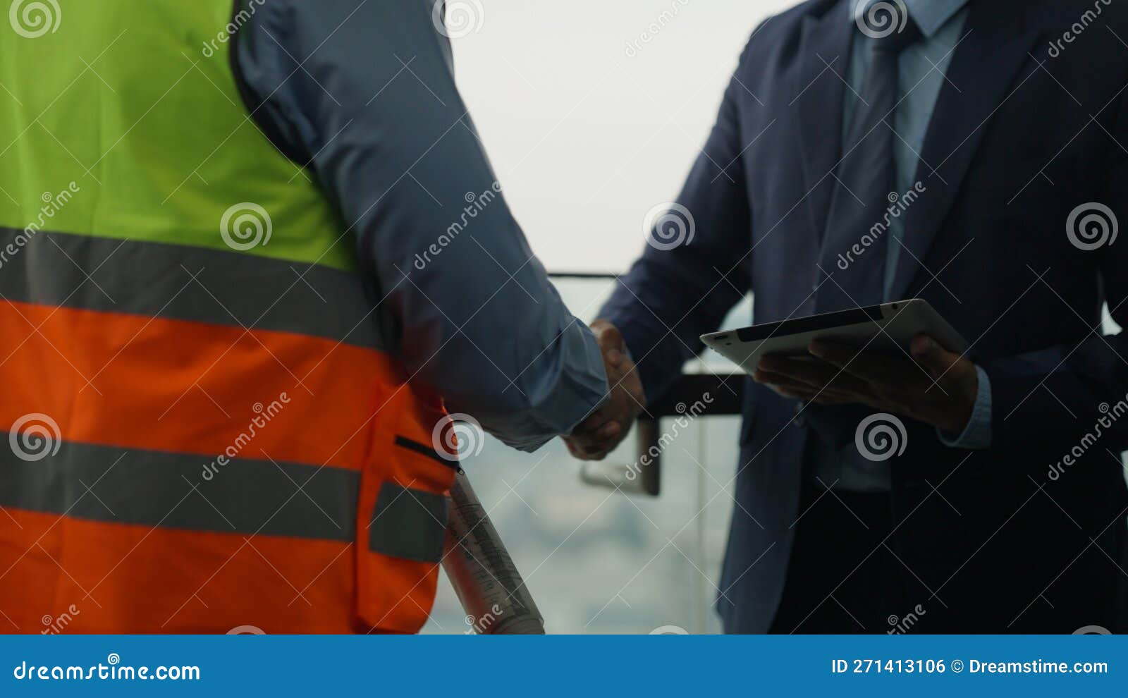Construction Workers Shaking Hands Businesspeople at Construction Site ...