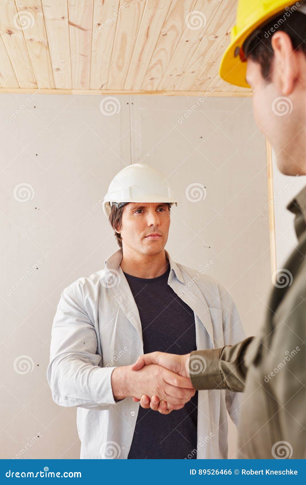Construction Workers Sharing Handshake Stock Photo - Image of blue ...