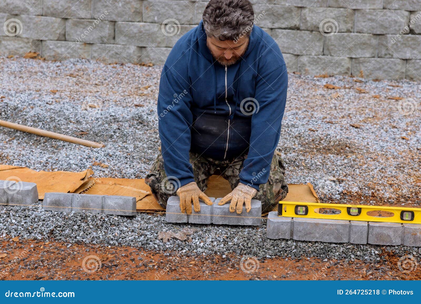 Construction Workers for a Sidewalk Consisting of Stone Concrete Pavers ...