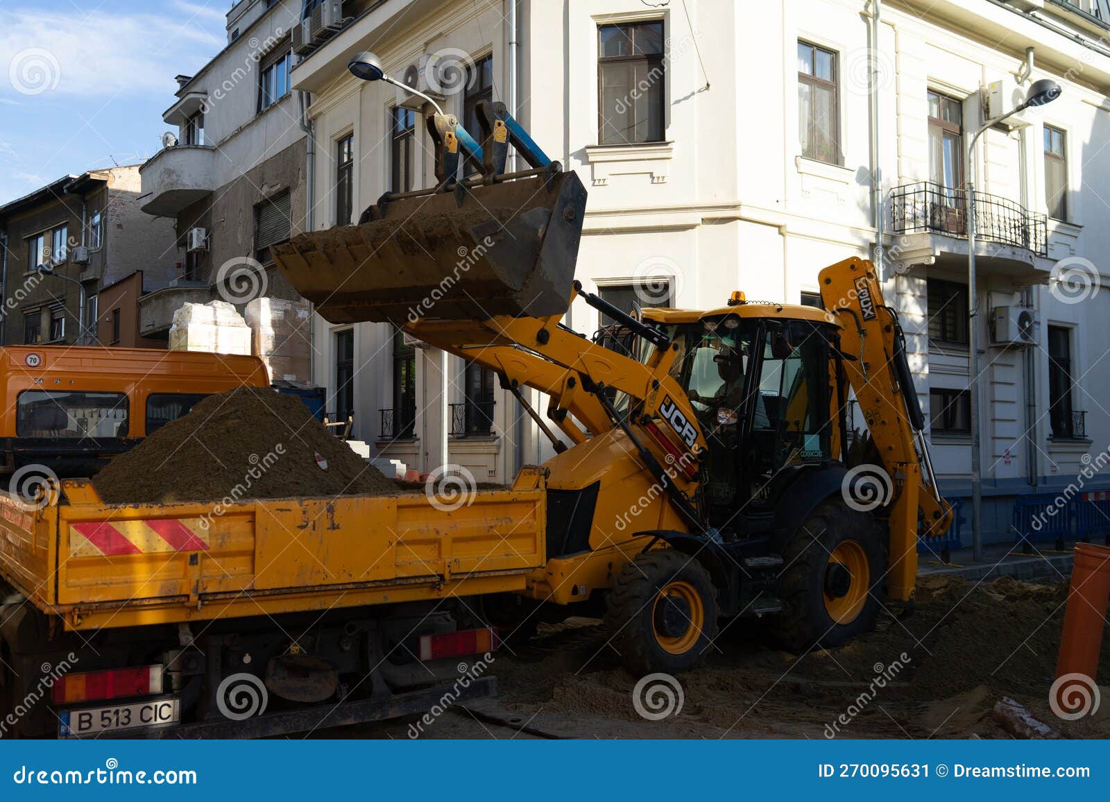 Construction Workers at Construction Site and Heavy Duty Bulldozer in ...