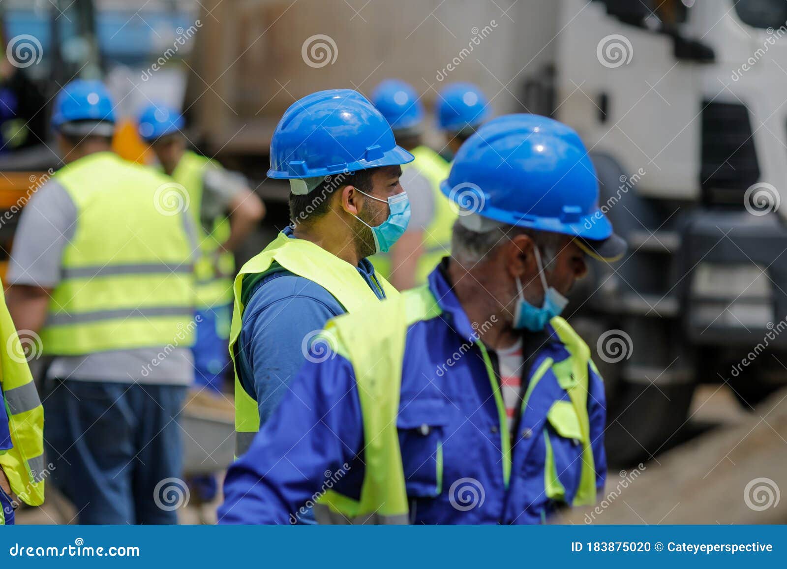 Construction Workers on a Construction Site with Protective Masks Due ...