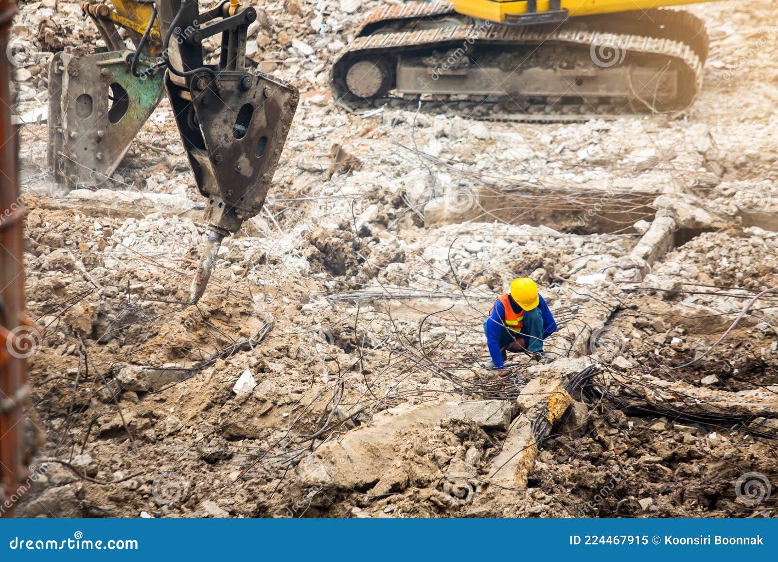 Construction Workers Sitting among the Rubble of Demolished Buildings ...