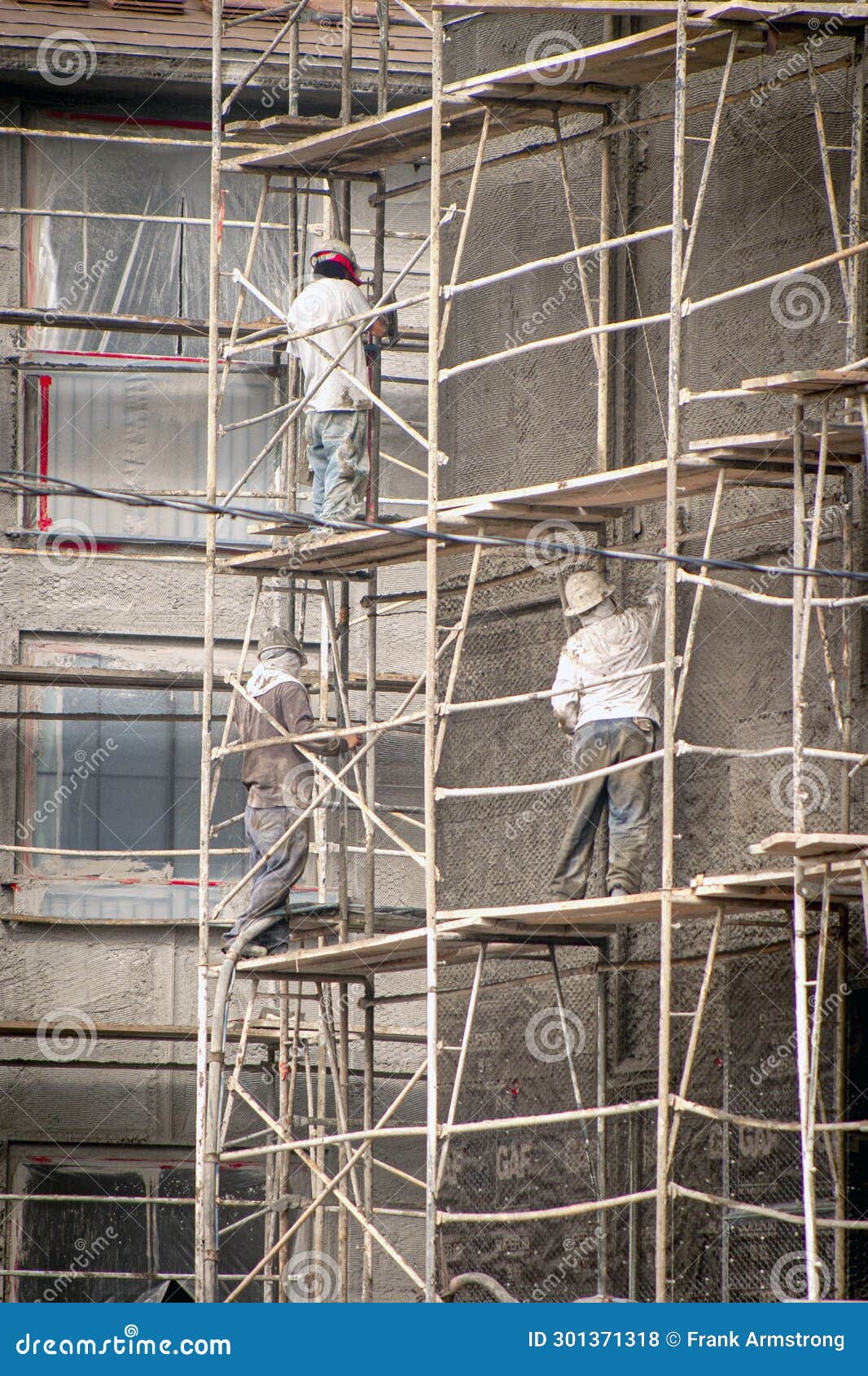 Construction Workers Spraying Stucco on the Exterior of a Building ...