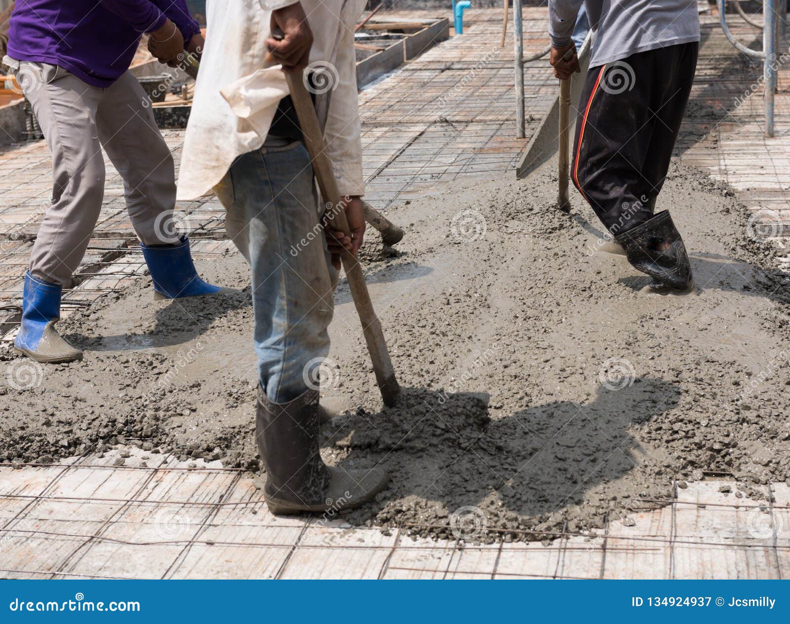 Construction Workers Spreading Freshly Poured Concrete Mix for Home ...